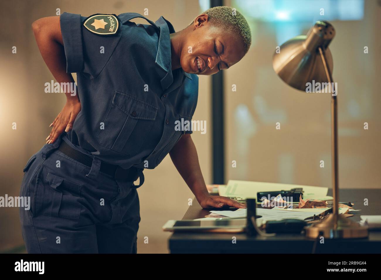 Police, woman and back pain in a cop station with spine problem and ...