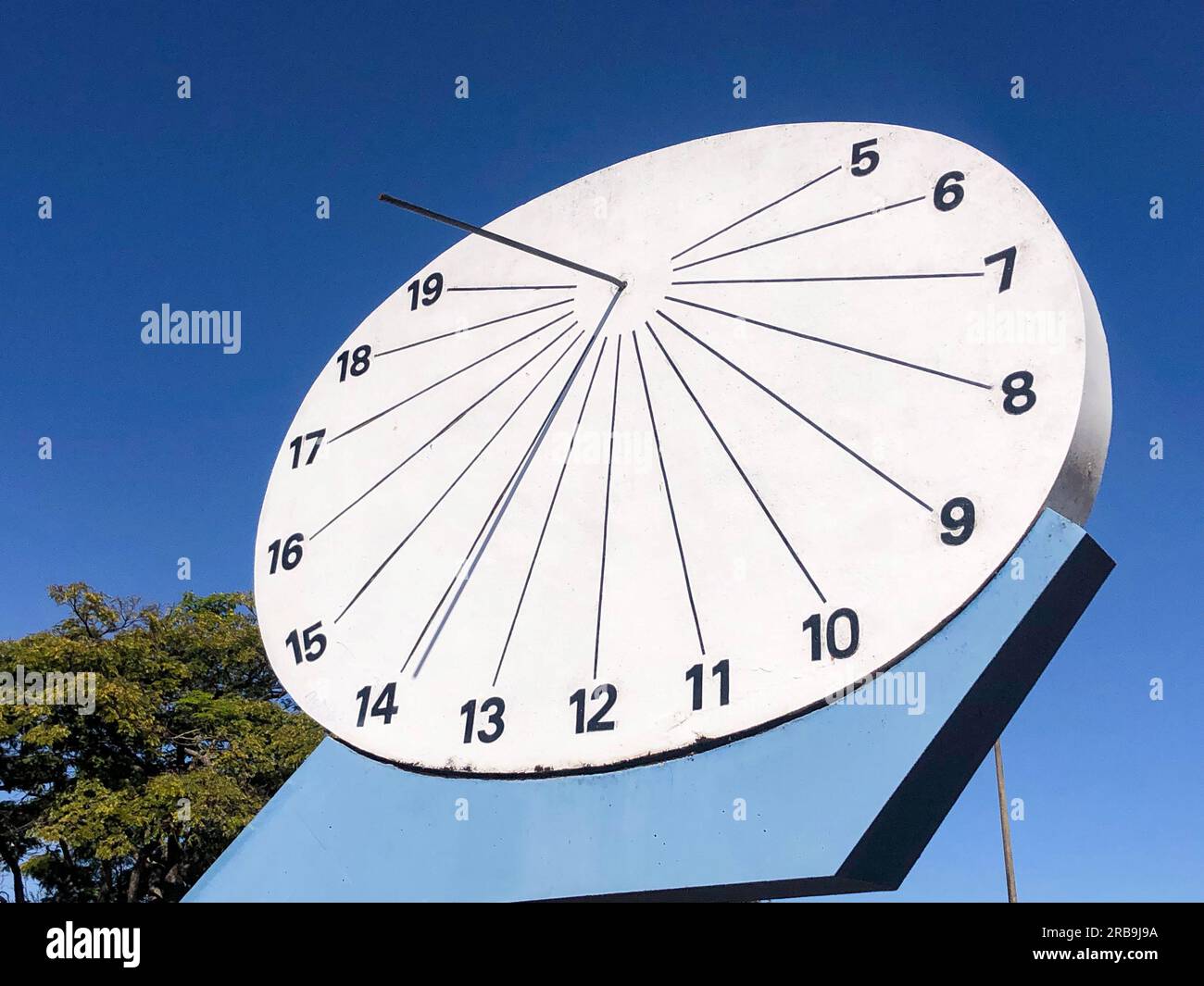 Traditional sun clock keeping time around 14:00h Stock Photo - Alamy