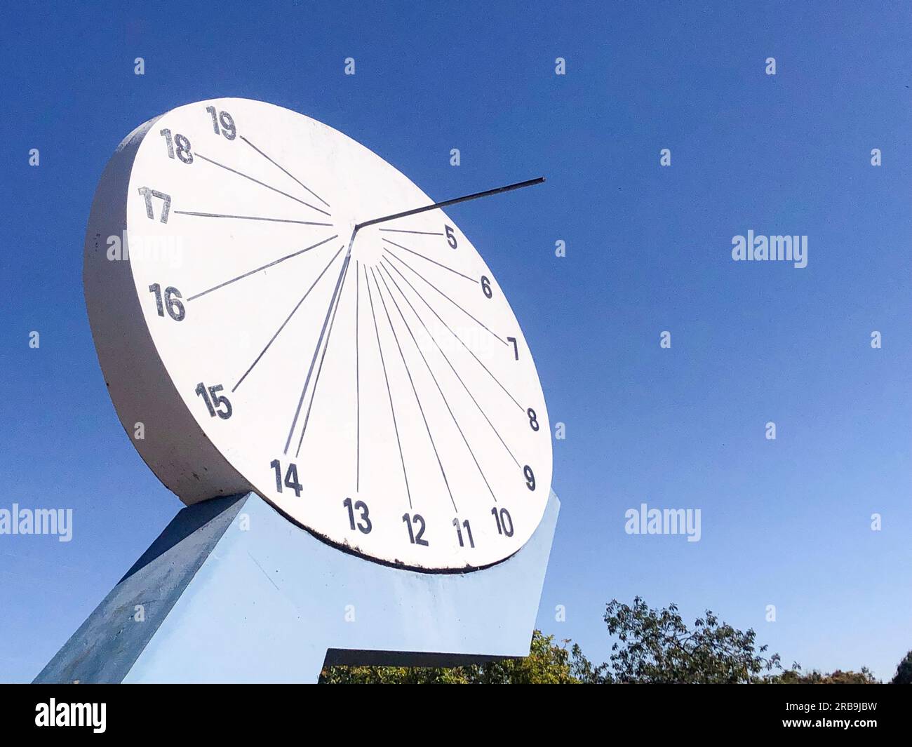 Traditional sun clock keeping time around 14:00h Stock Photo - Alamy
