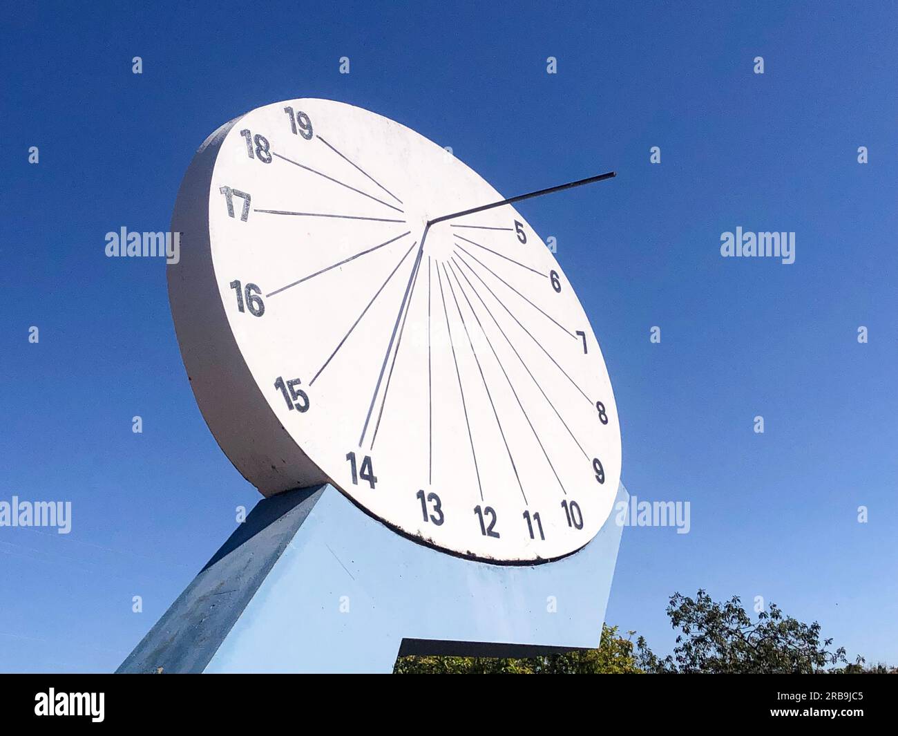 Traditional sun clock keeping time around 14:00h Stock Photo - Alamy