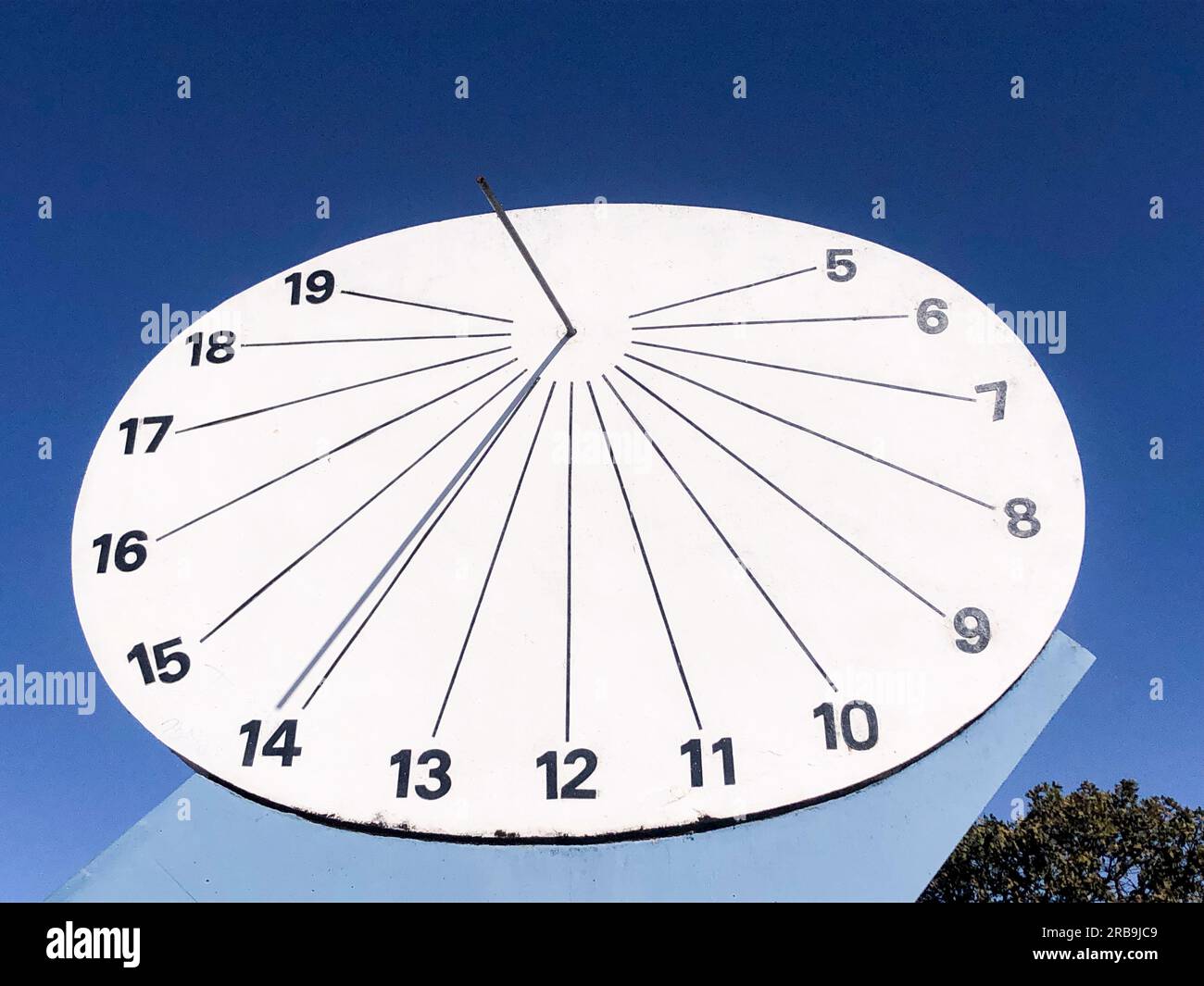 Traditional sun clock keeping time around 14:00h Stock Photo - Alamy