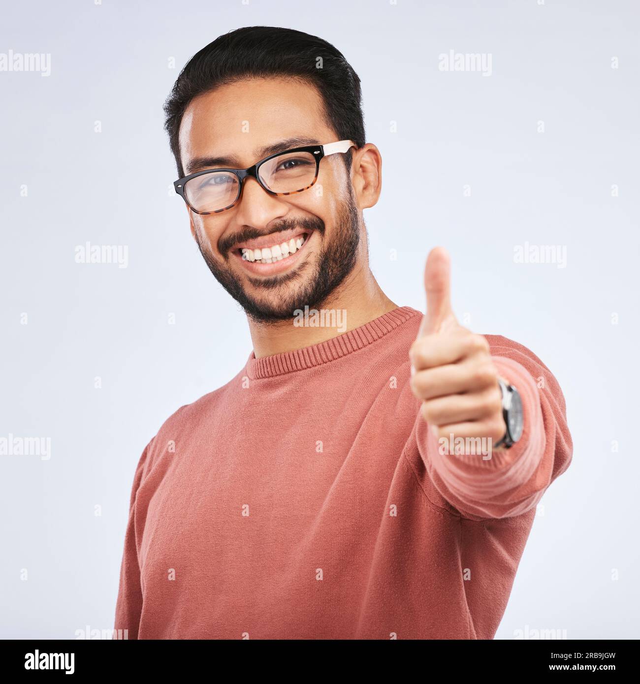 Thumbs up, portrait and asian man with hands for success in studio ...
