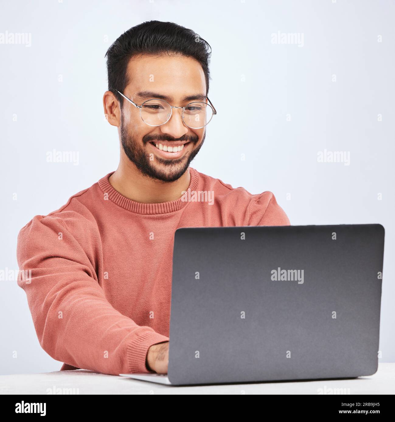 Laptop, IT and man with glasses in studio, white background and ...