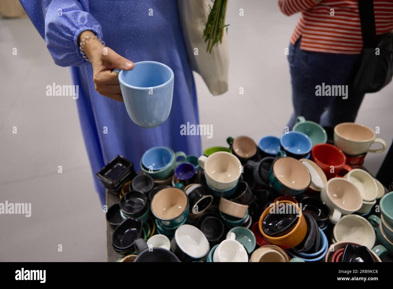 A woman picking decorative ceramics for a gift. Unrecognizable young ...