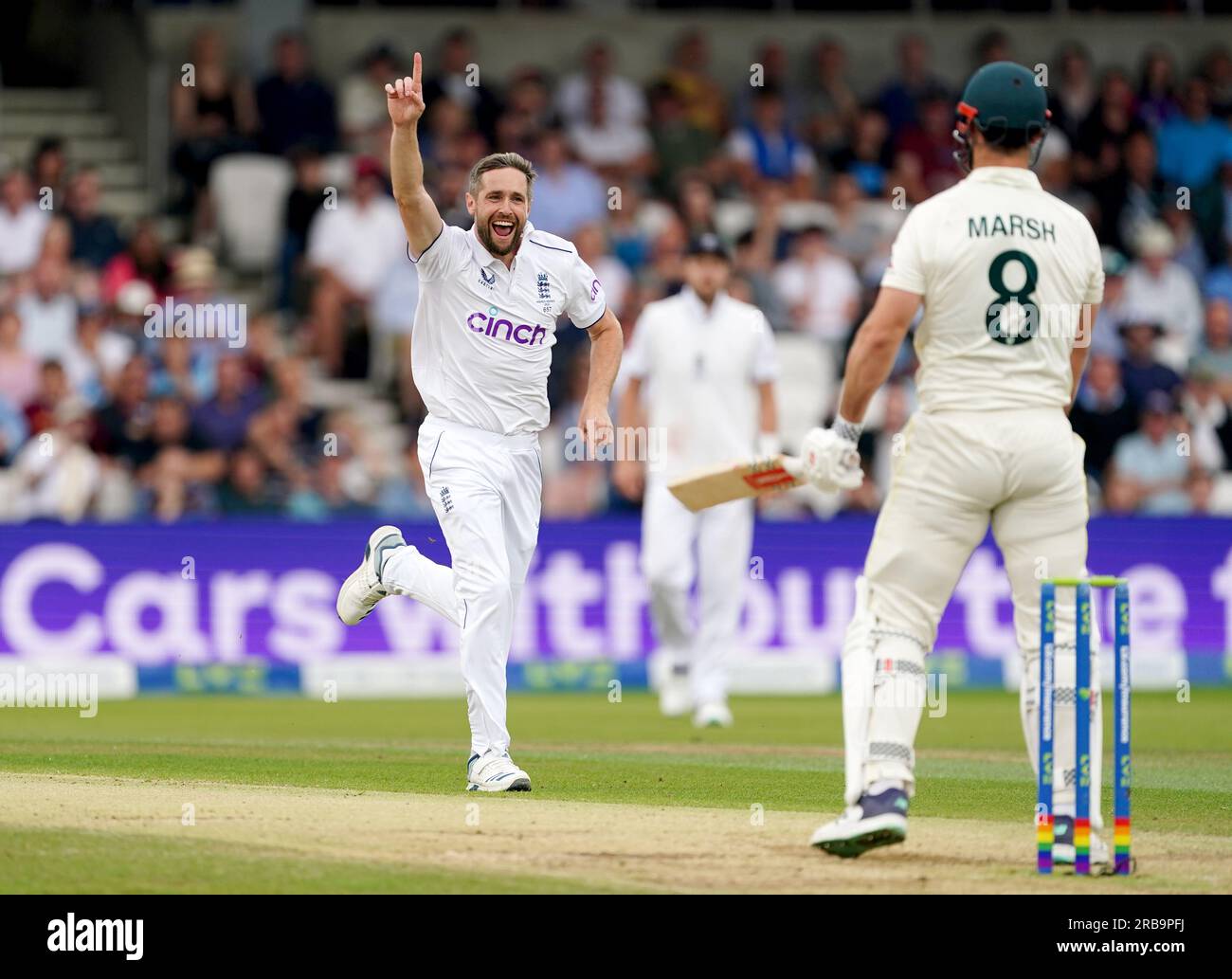 England's Chris Woakes (left) celebrates after taking the wicket of ...