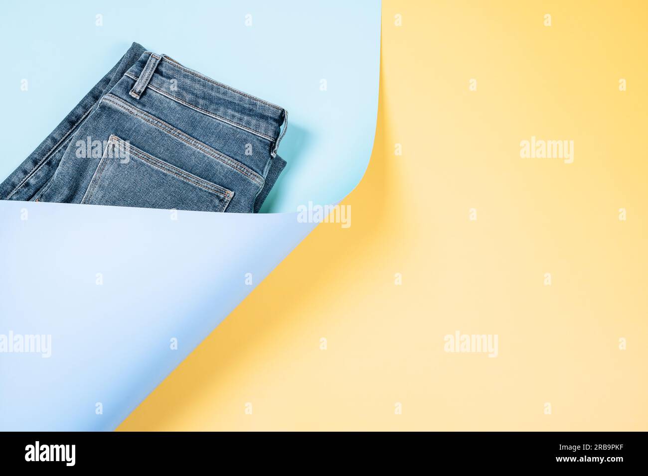 Trendy composition with part of new jeans on light blue and pastel ...