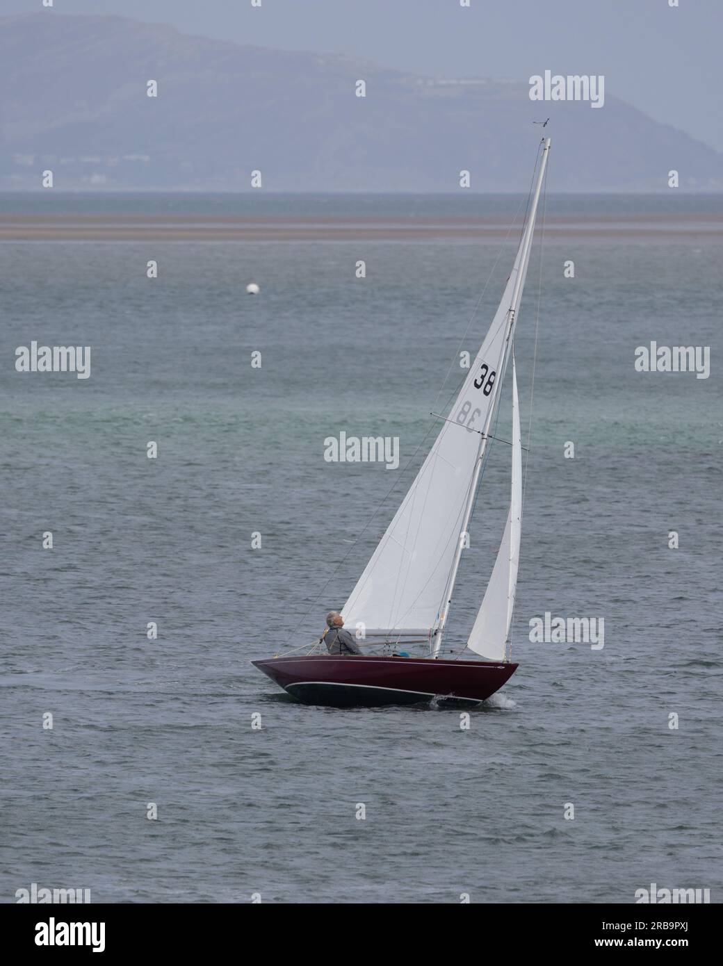 A Fife One Design yacht sailing off Beaumaris in the Menai Straits ...
