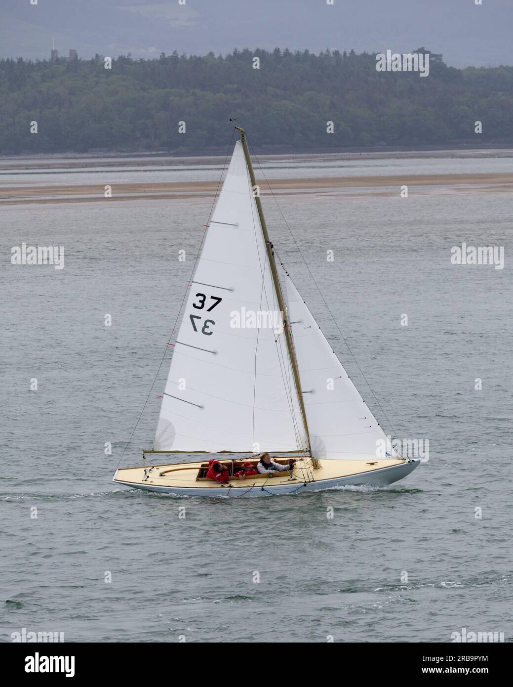 A Fife One Design yacht sailing off Beaumaris in the Menai Straits ...