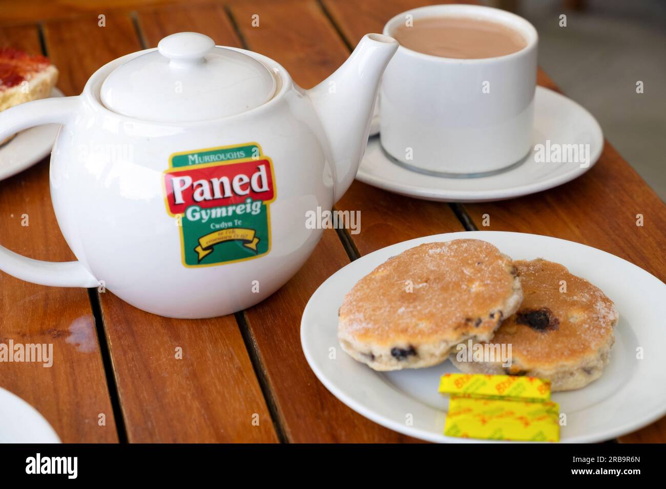 Welsh cakes and teapot on table with cup and saucer in restaurant cafe ...