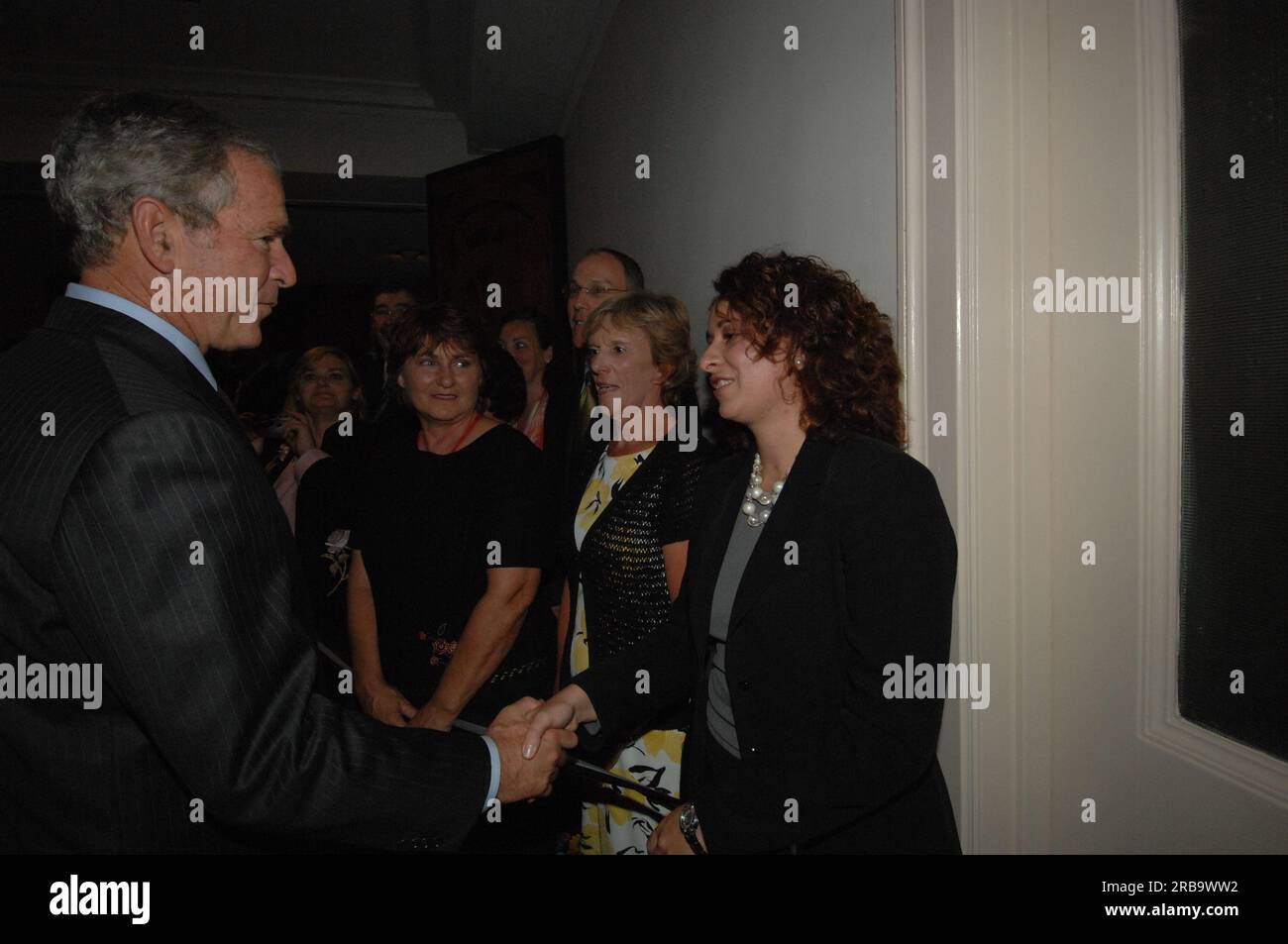 Department staff greeting President George W. Bush, from behind rope ...