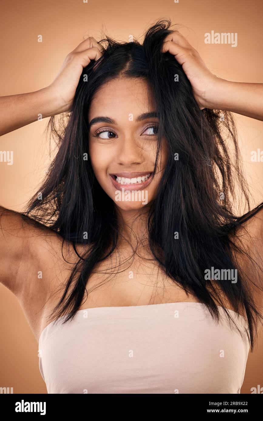 Mess, hair and face of woman in studio with haircare problem, damaged ...