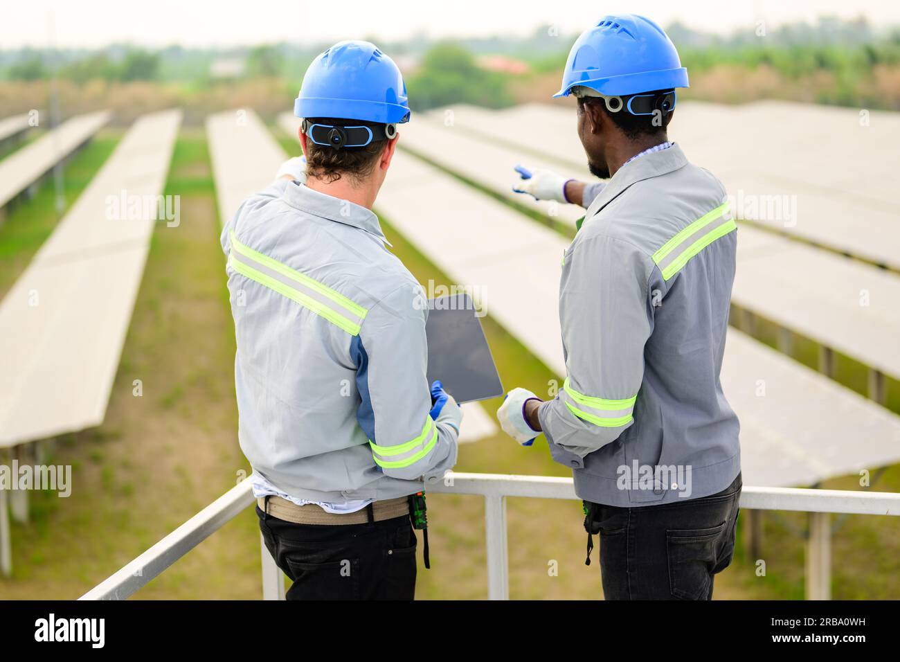 Happy maintenance engineers checking and maintaining solar panels Stock ...