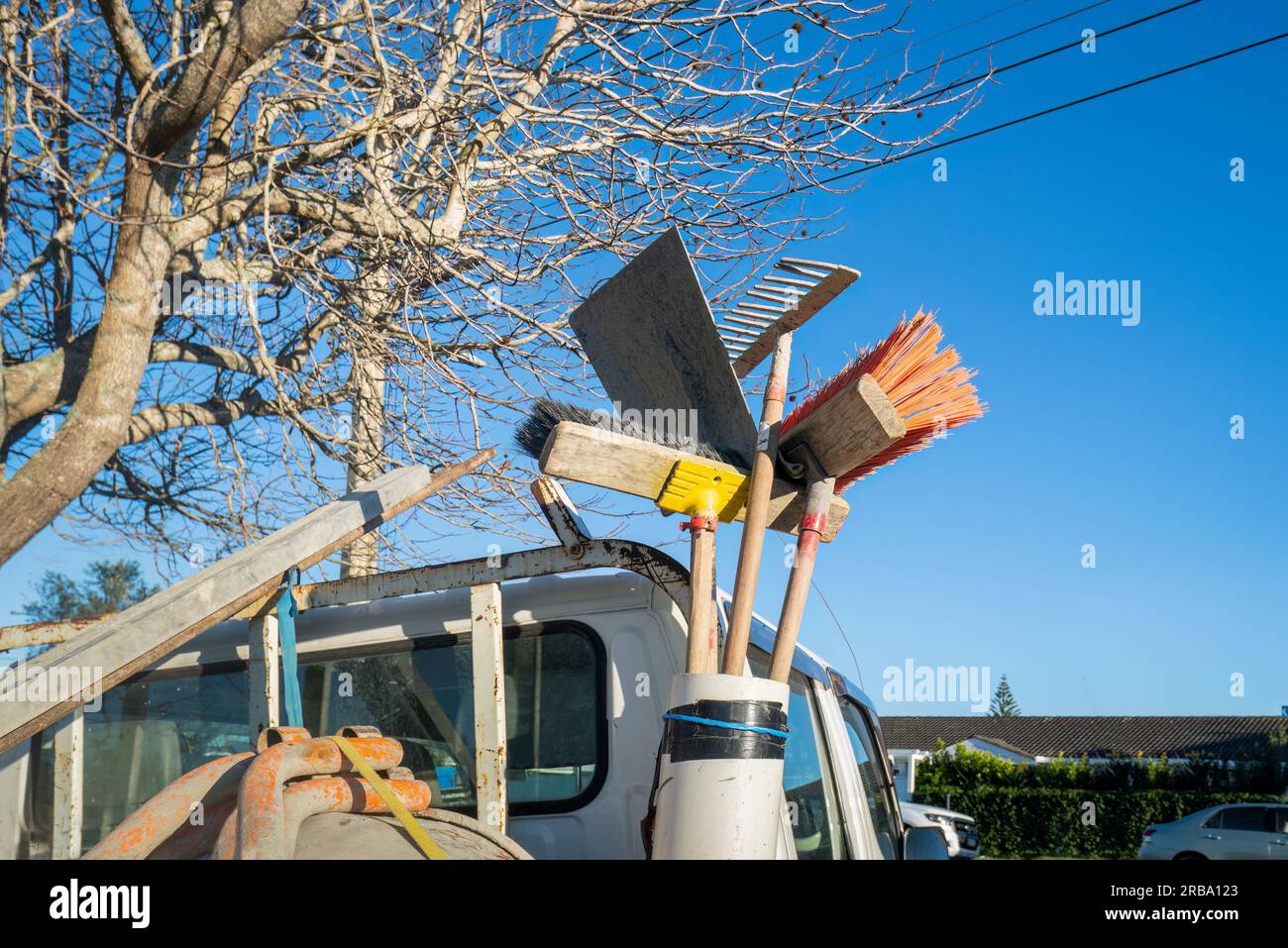Truck with cleaning tools and building material parked by the road ...
