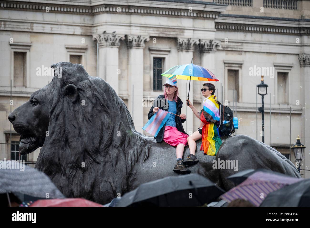 London, UK. 8 July 2023. People in the rain in Trafalgar Square, where ...