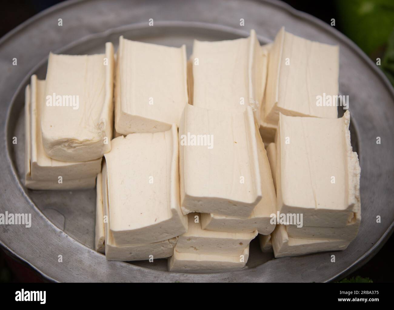 Plate of Raw Tofu at the street market for sale Stock Photo - Alamy