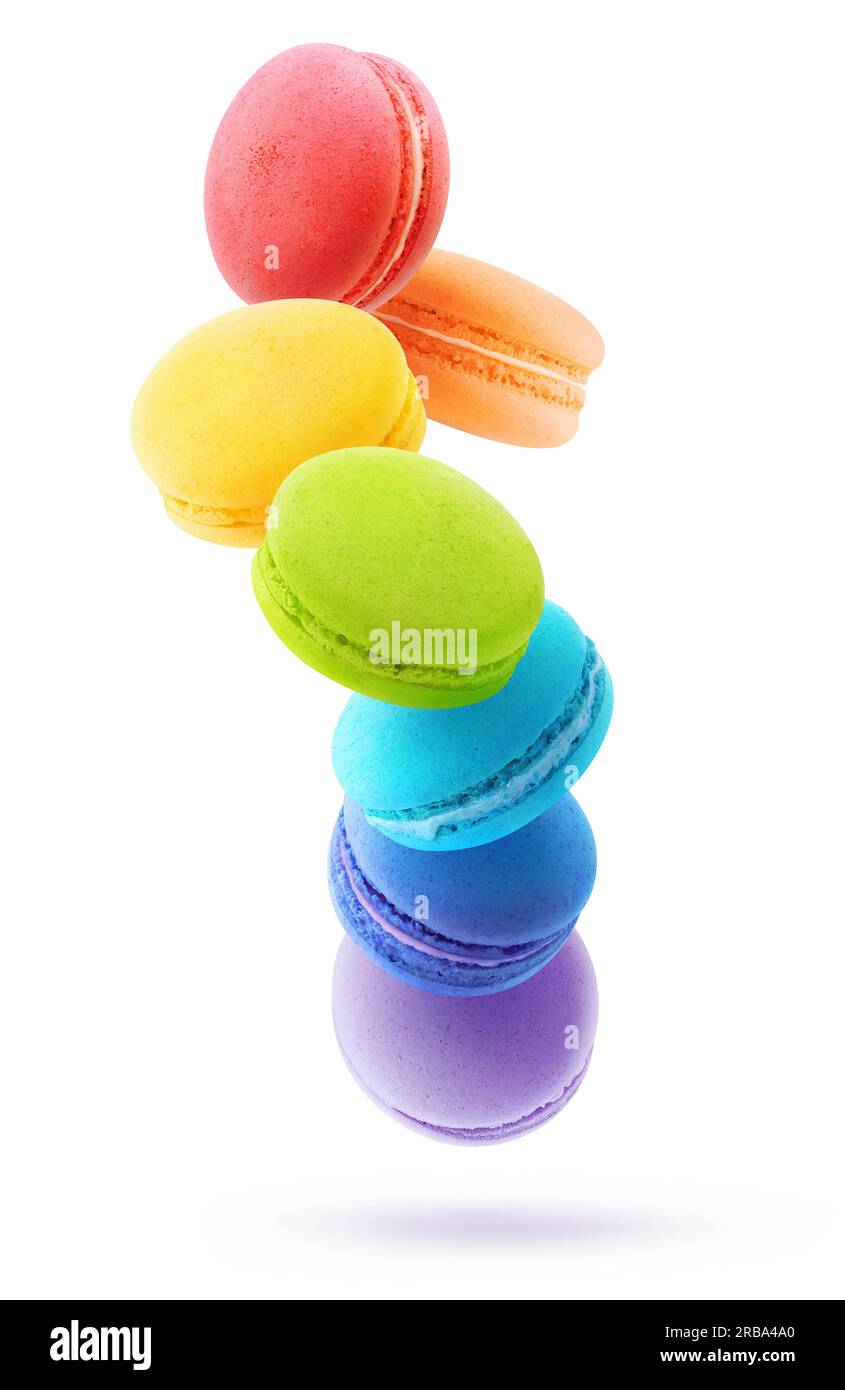 Rainbow coloured macaroons levitation, vertical shot isolated on white ...