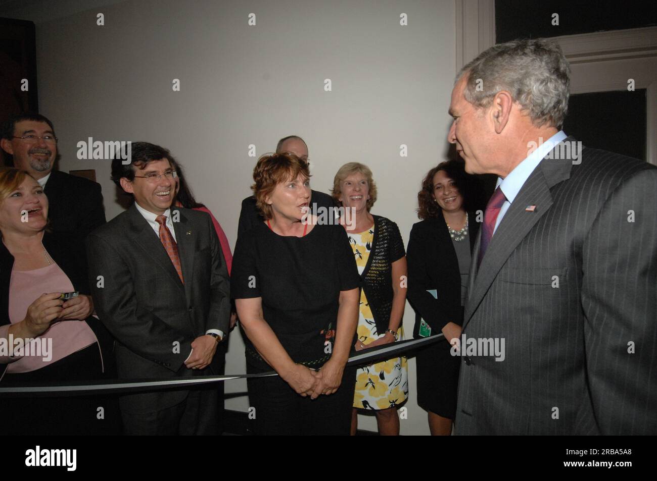 Department staff greeting President George W. Bush, from behind rope ...