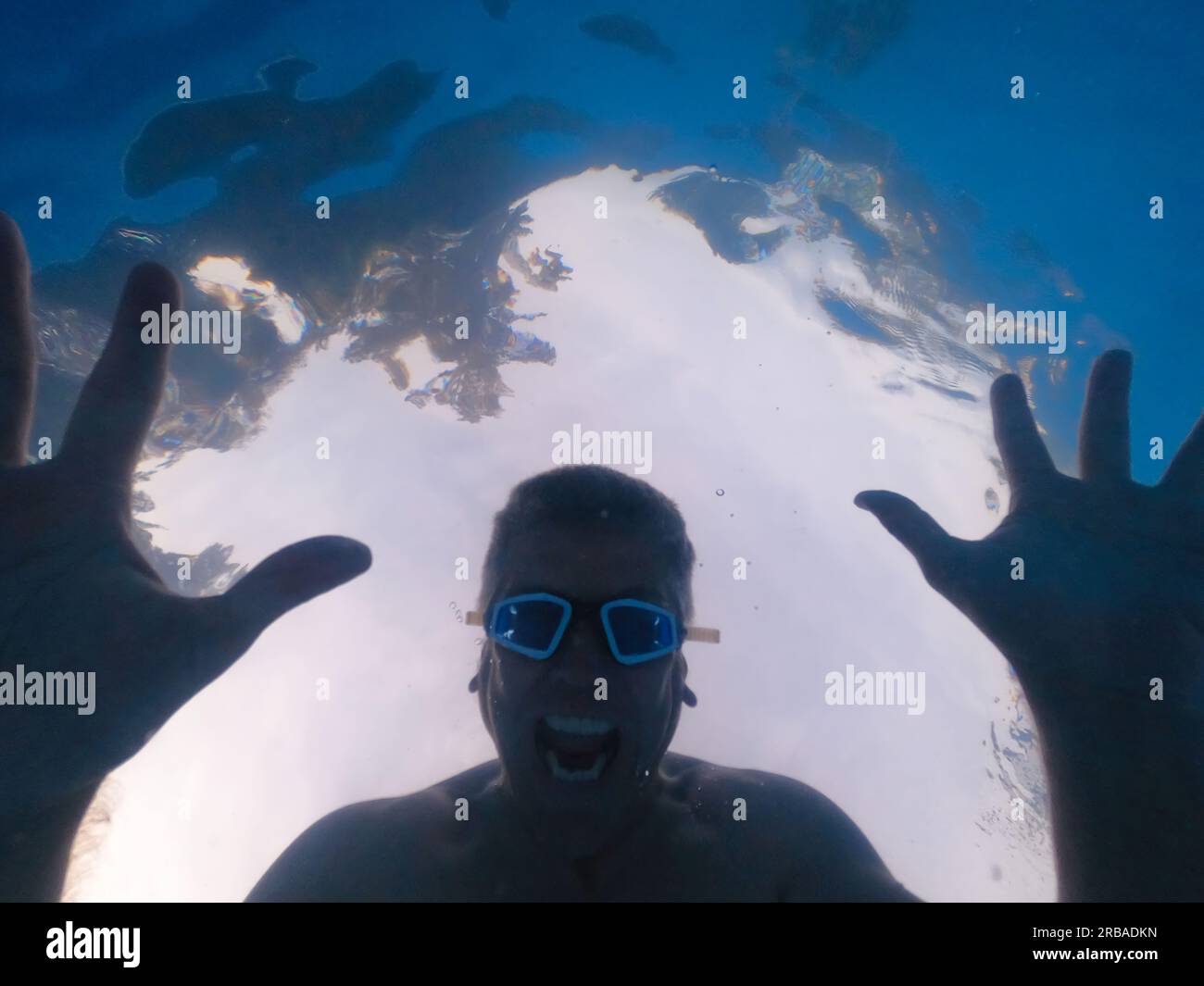 Person Underwater Looking Up