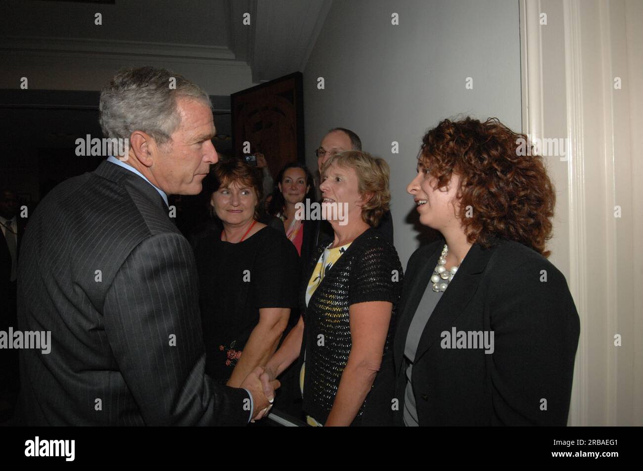 Department staff greeting President George W. Bush, from behind rope ...
