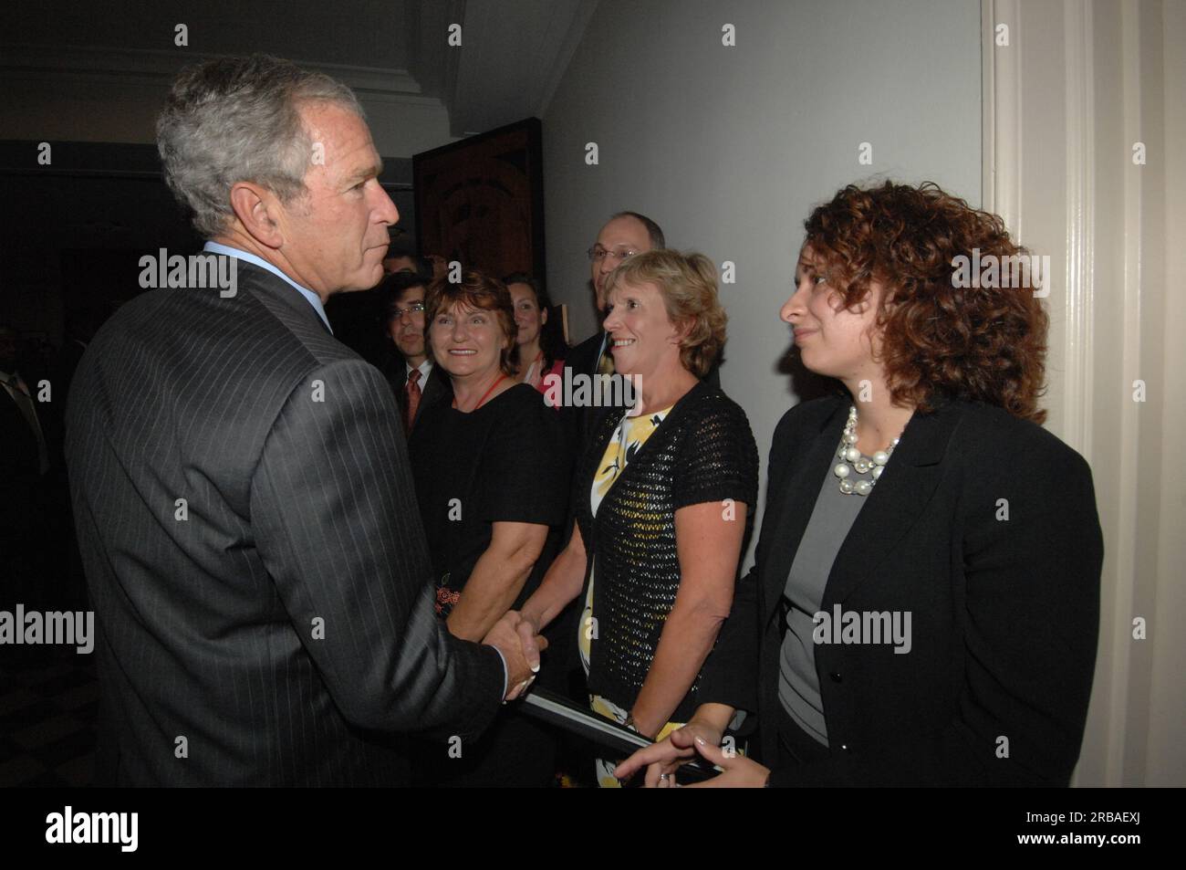 Department staff greeting President George W. Bush, from behind rope ...