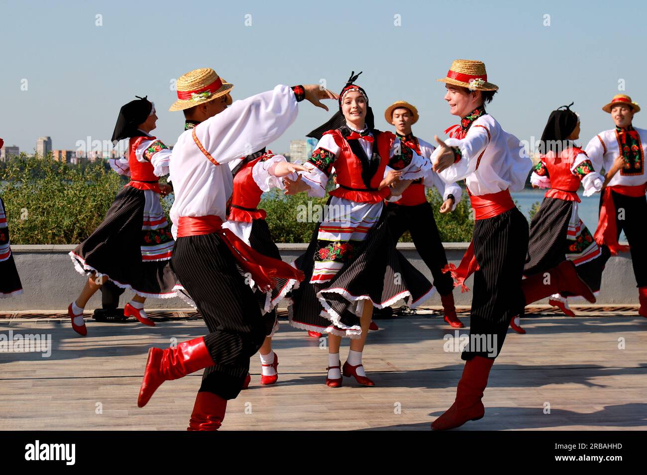 Young girls and boys dance national Ukrainian dance in folk costumes ...