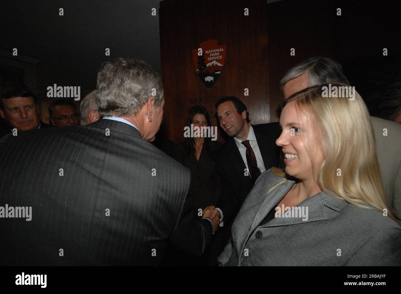 Department staff greeting President George W. Bush, from behind rope ...