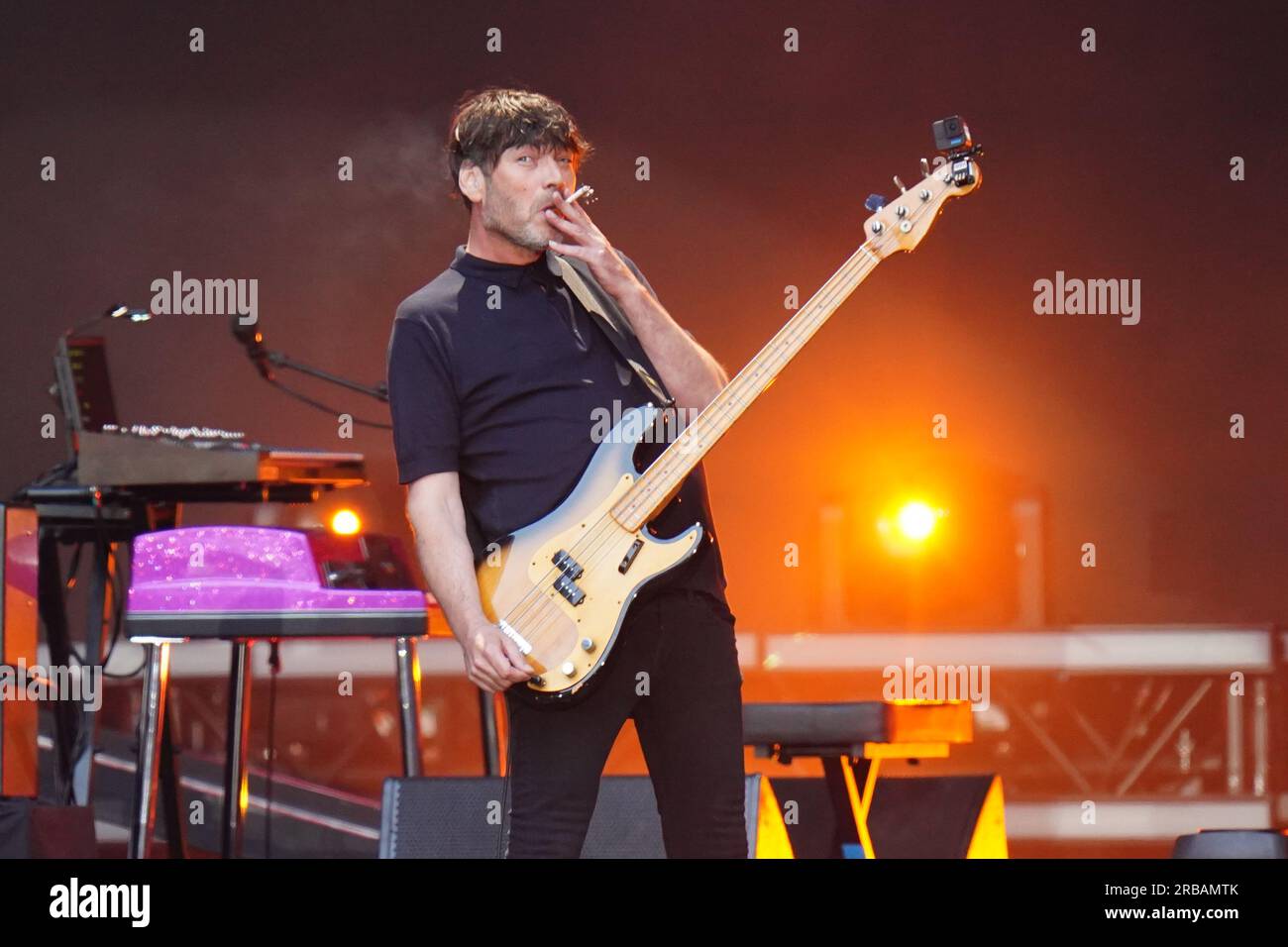 Alex James of Blur performing on stage at Wembley Stadium in London ...