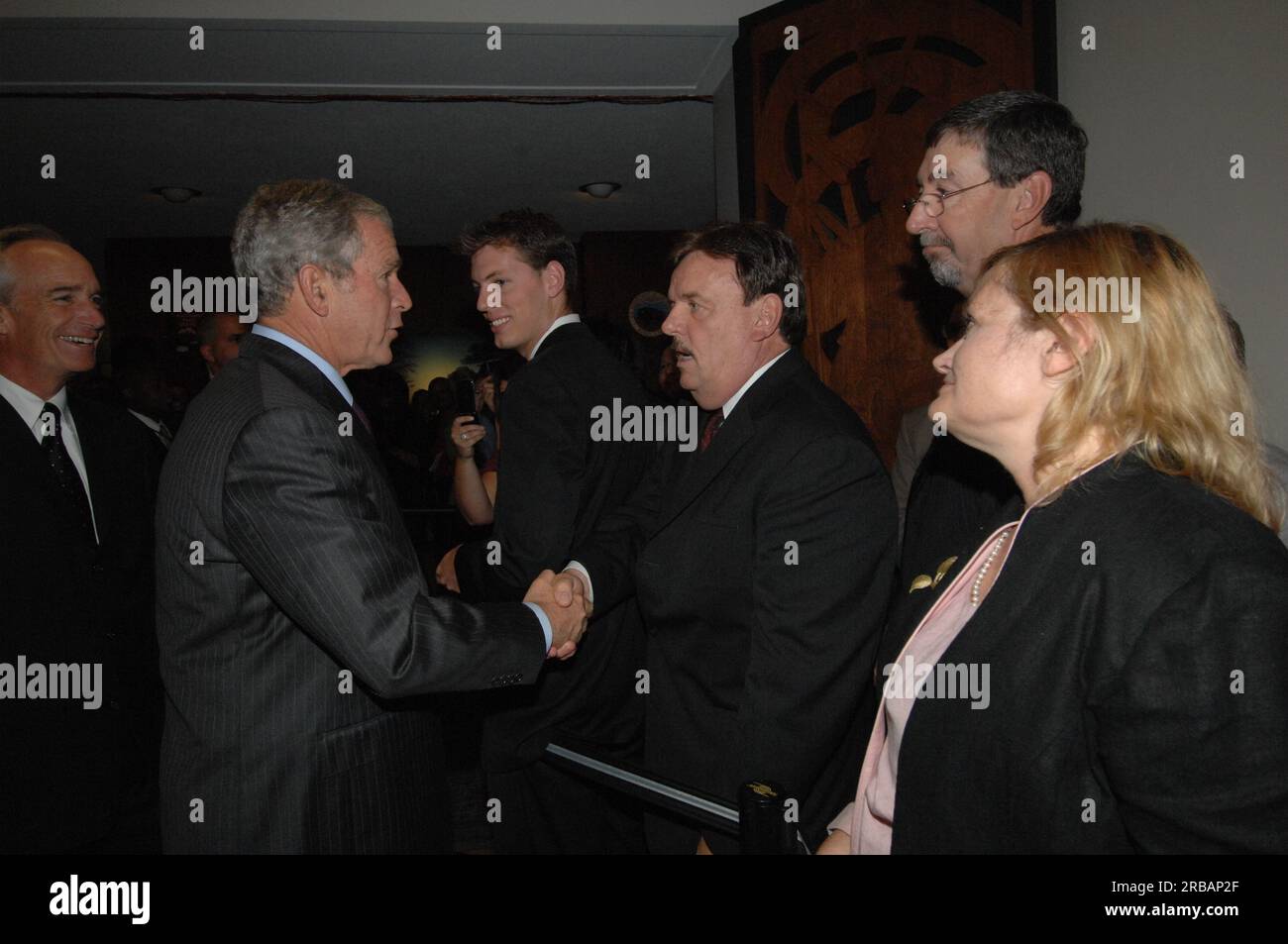 Department staff greeting President George W. Bush, from behind rope ...