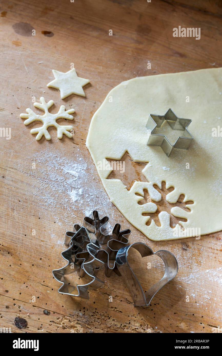 Christmas bakery, short pastry is rolled out on a baking board, cookie ...