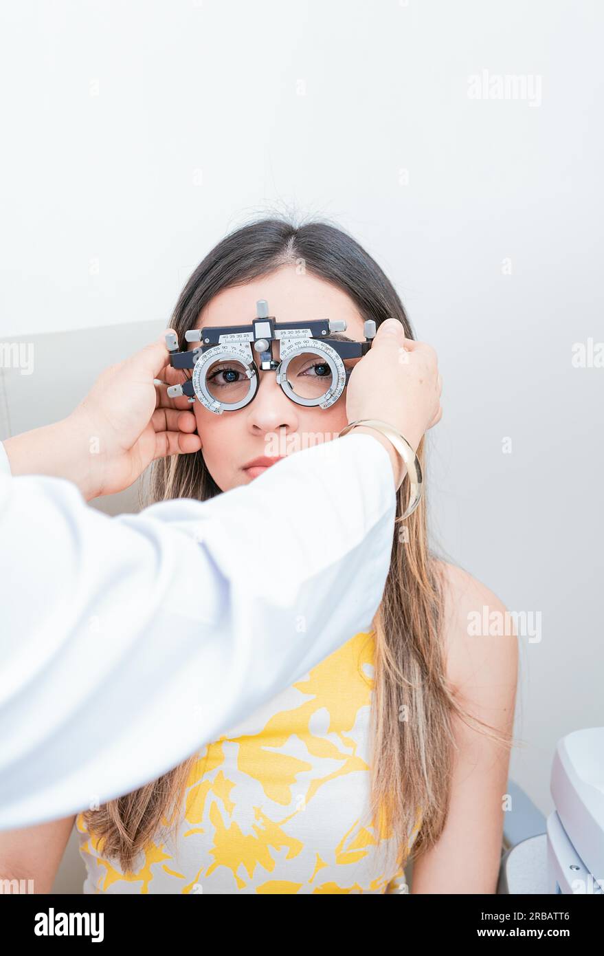 Doctor adjusting vision of patient with optometrist trial frame ... Doctor adjusting vision of patient with optometrist trial frame ...