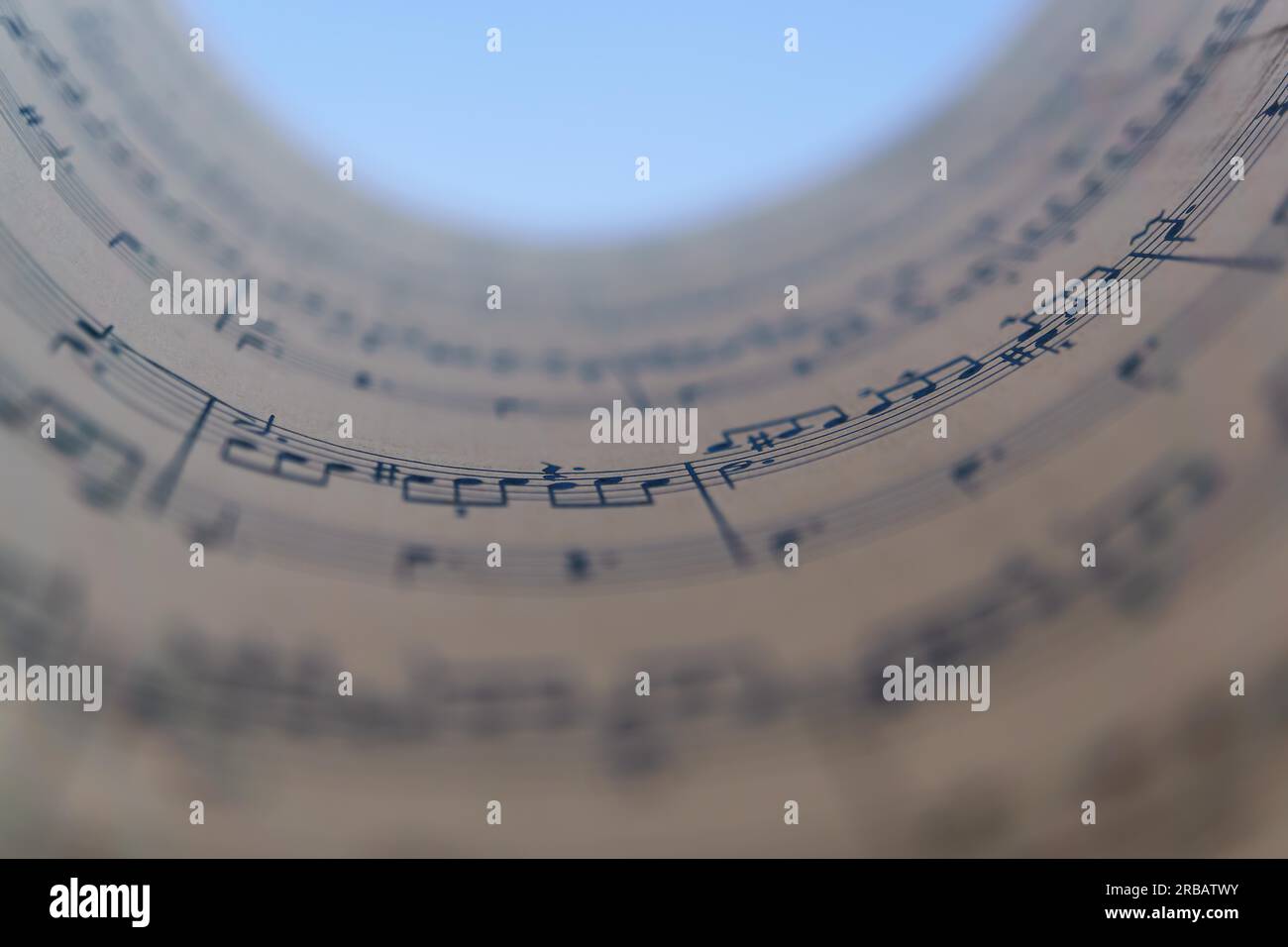 Circular rolled sheet music with blue blurred background Stock Photo ...