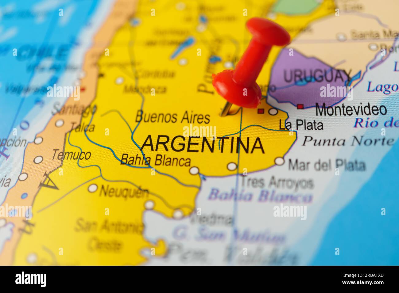 Argentina marked with a red thumbtack on a map with an out-of-focus ...