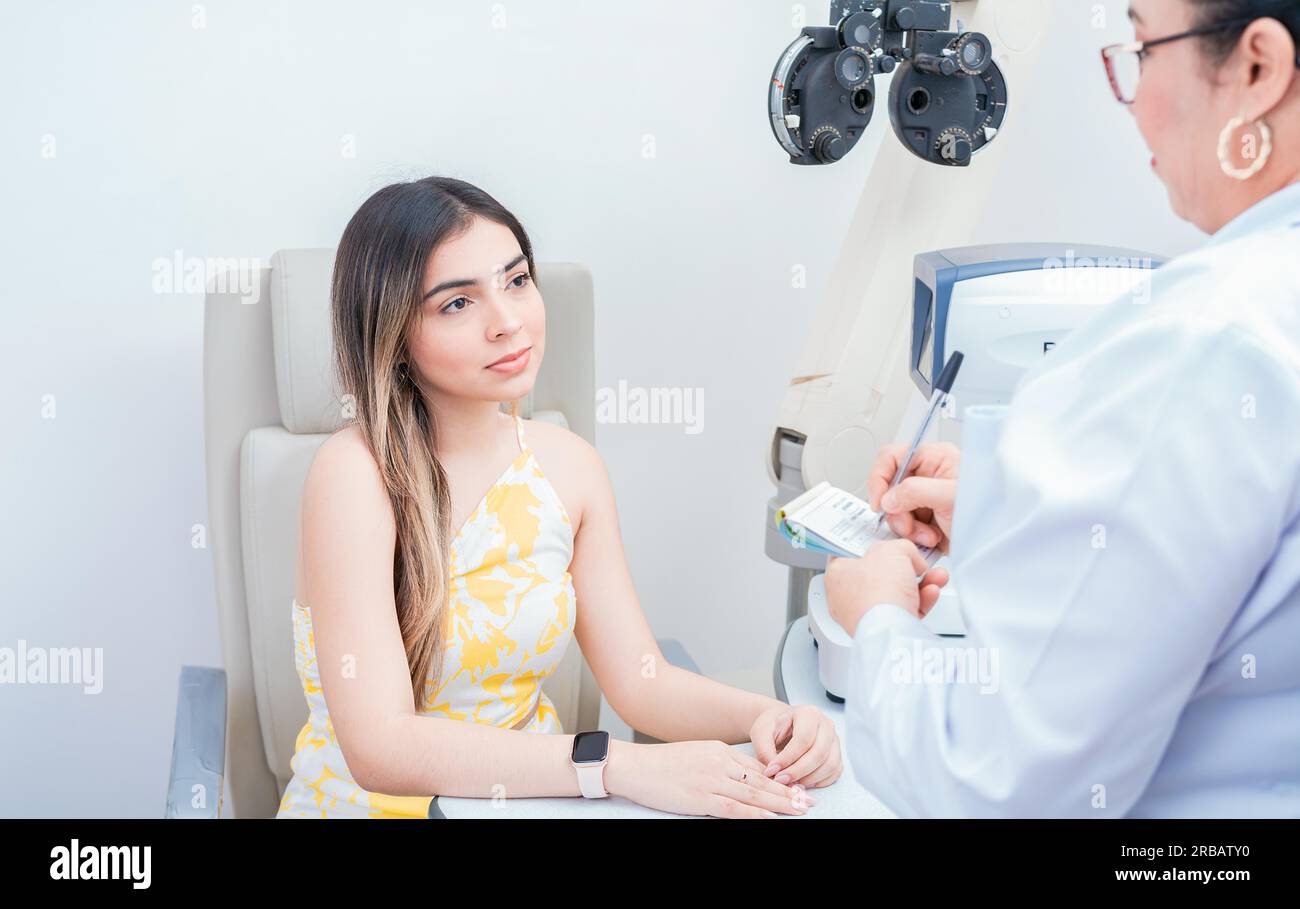 Female patient having consultation with optometrist in office ...