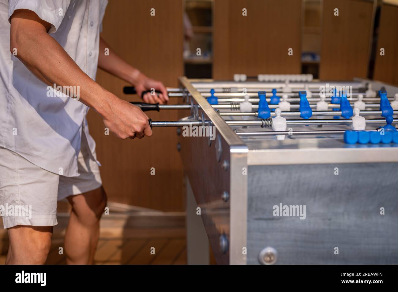 Hand playing foosball. People enjoying table soccer game Stock Photo ...