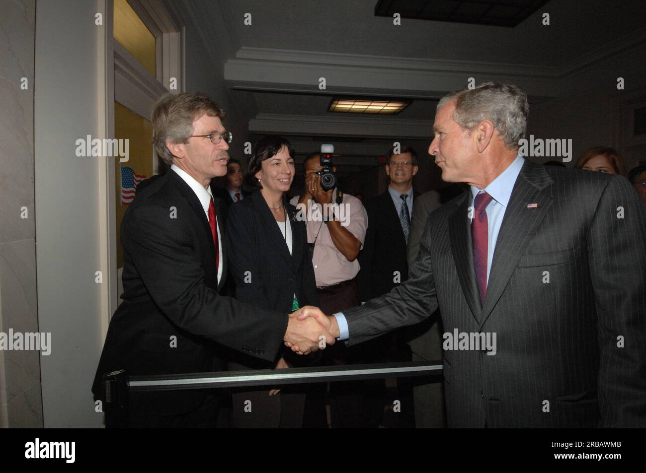Department staff greeting President George W. Bush, from behind rope ...
