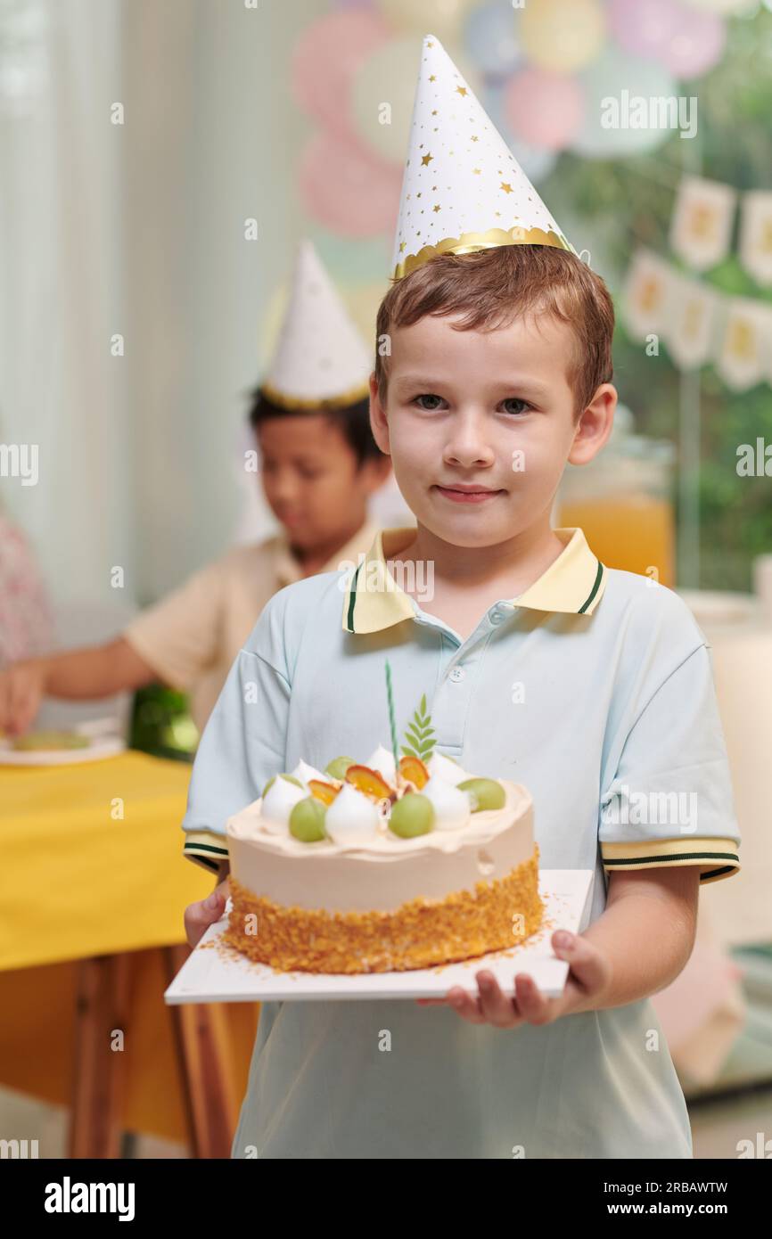 Boy carrying cake hi-res stock photography and images - Alamy