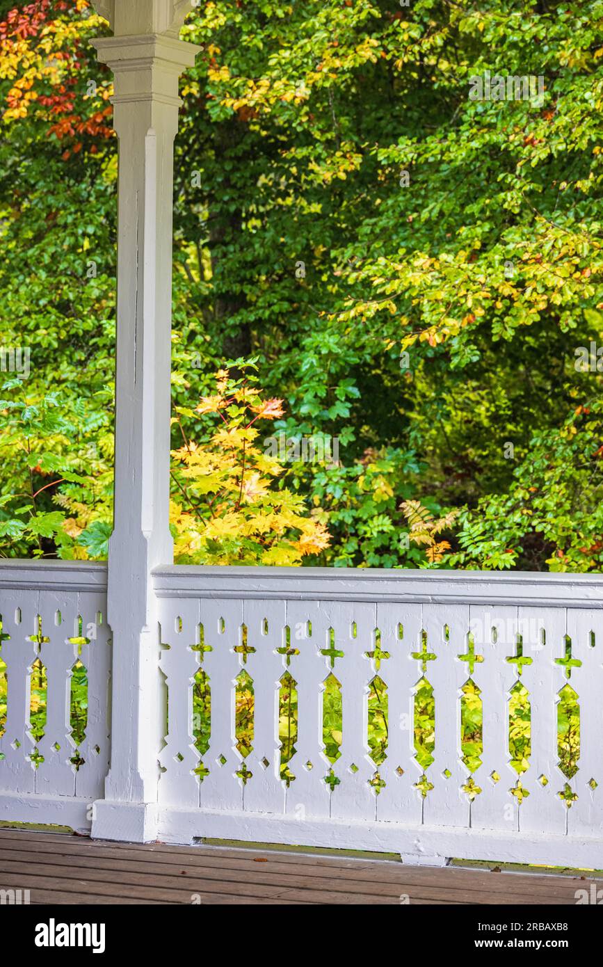 Railing with wooden carpentry by a deciduous forest with autumn colors ...
