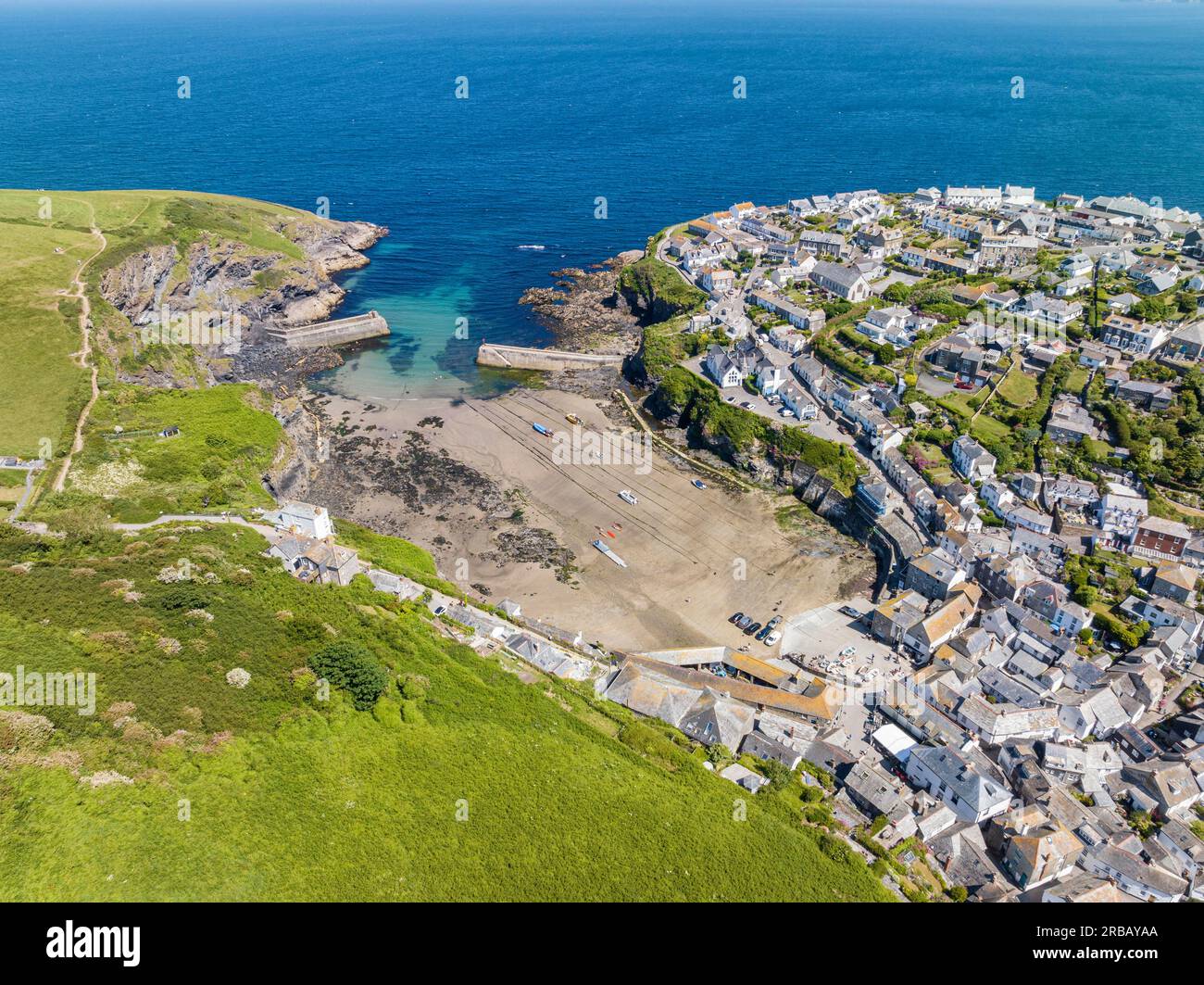 Aerial view of Port Isaac, with the harbour at low tide, North Cornwall ...