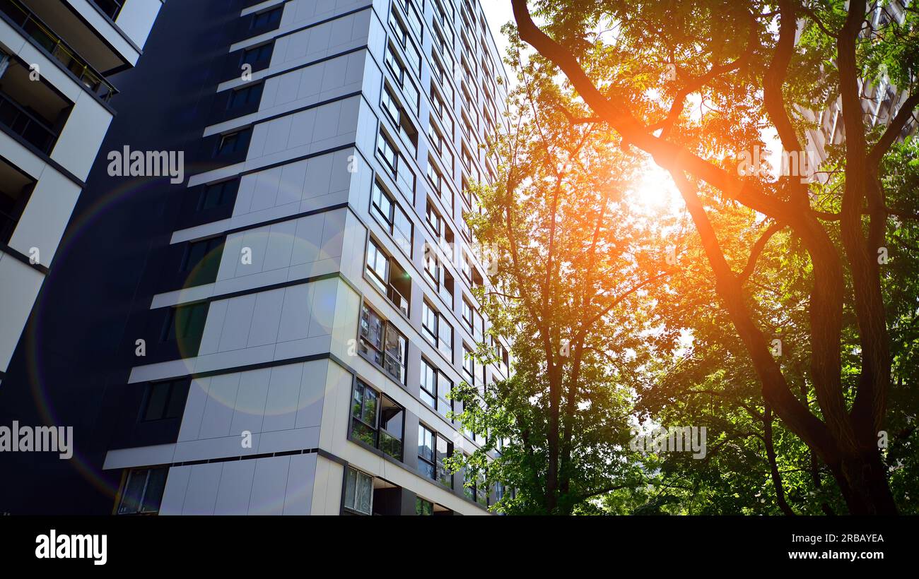 A modern residential building in the vicinity of trees. Ecology and ...