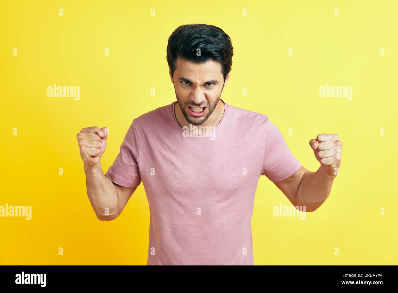 Angry man with fists up on yellow background. stress emotions concept ...