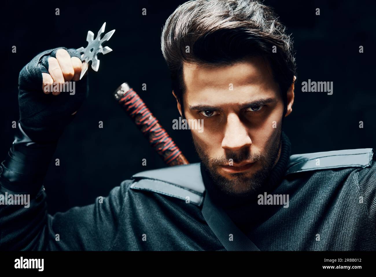 Warrior fighter with a sword and shuriken ready to stab enemy over ...