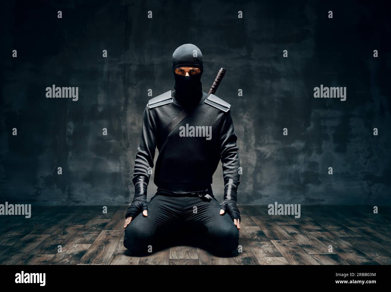 Ninja kneeling posing with a sword over black background. japanese ...