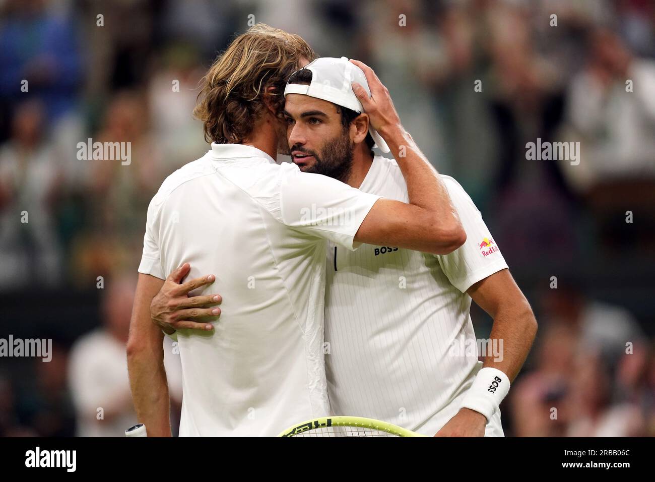Matteo Berrettini and Alexander Zverev (left) embrace at the net after their match on day six of ...