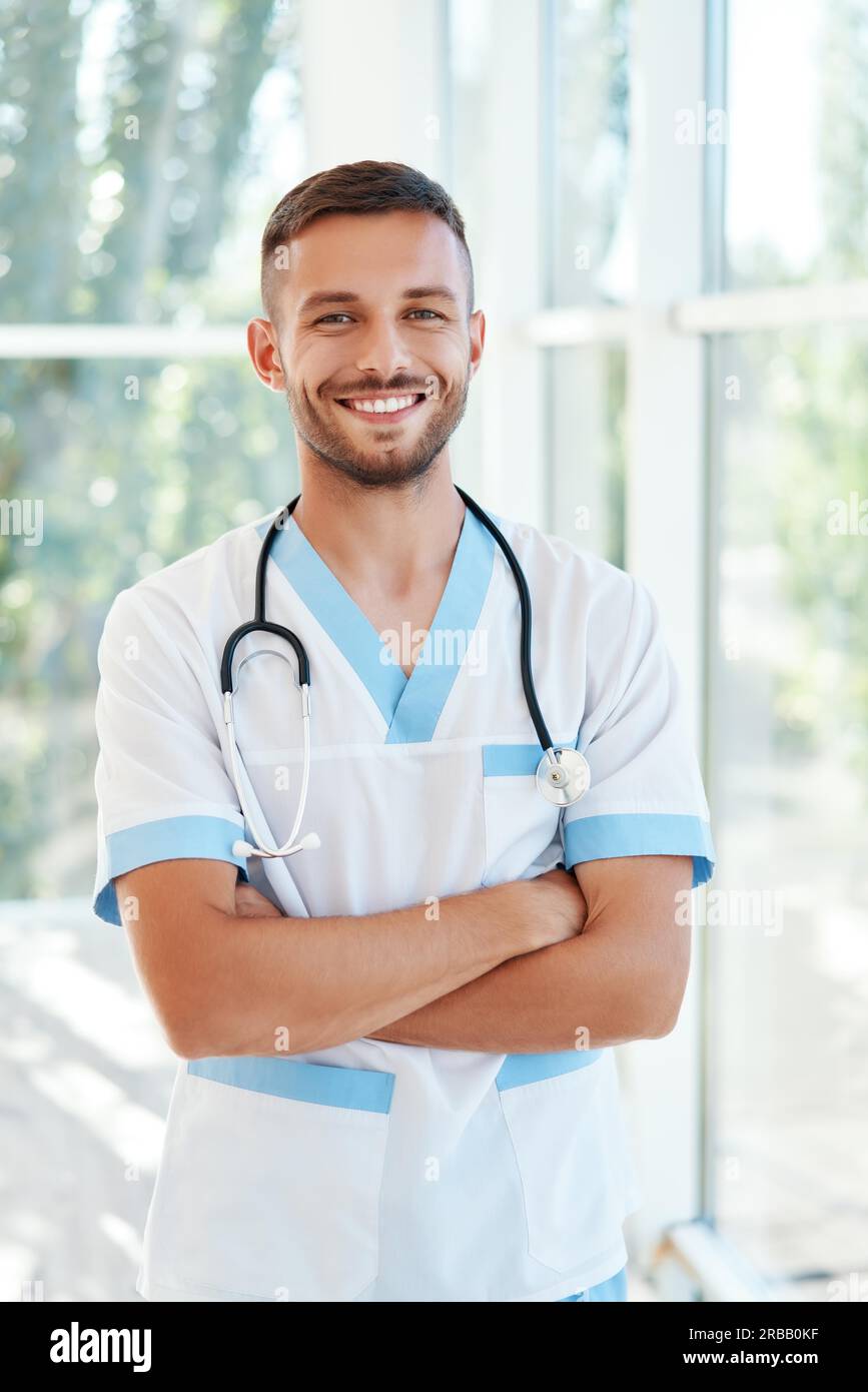 Portrait of confident smiling male doctor with stethoscope in medical ...