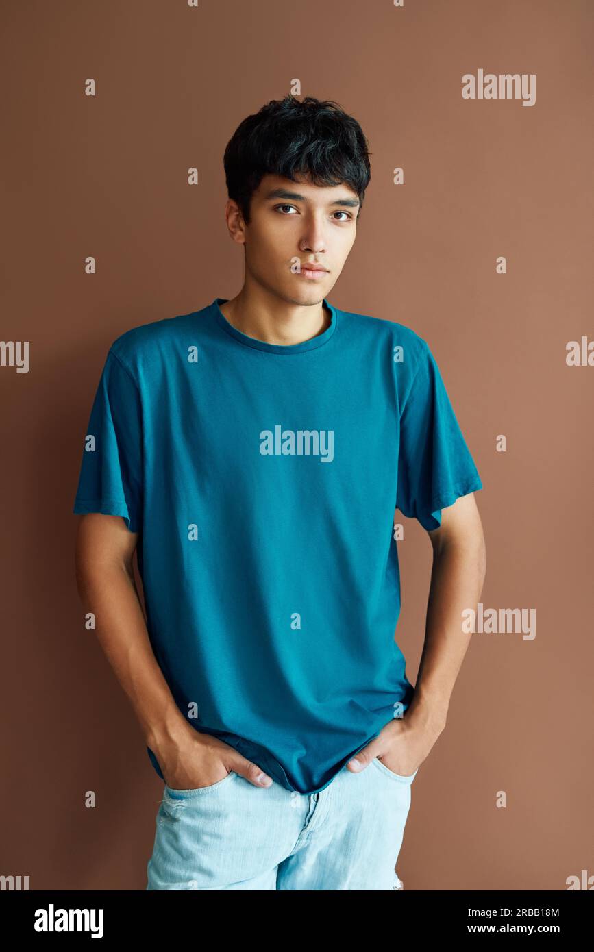 Young handsome Mixed-race man posing on studio background looking to ...