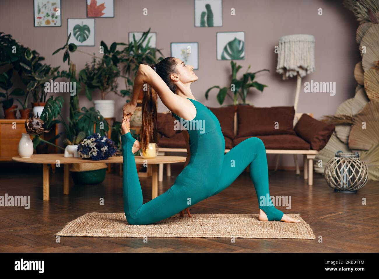 Young Sporty Woman Practicing Yoga At Home Doing One Legged King Pigeon