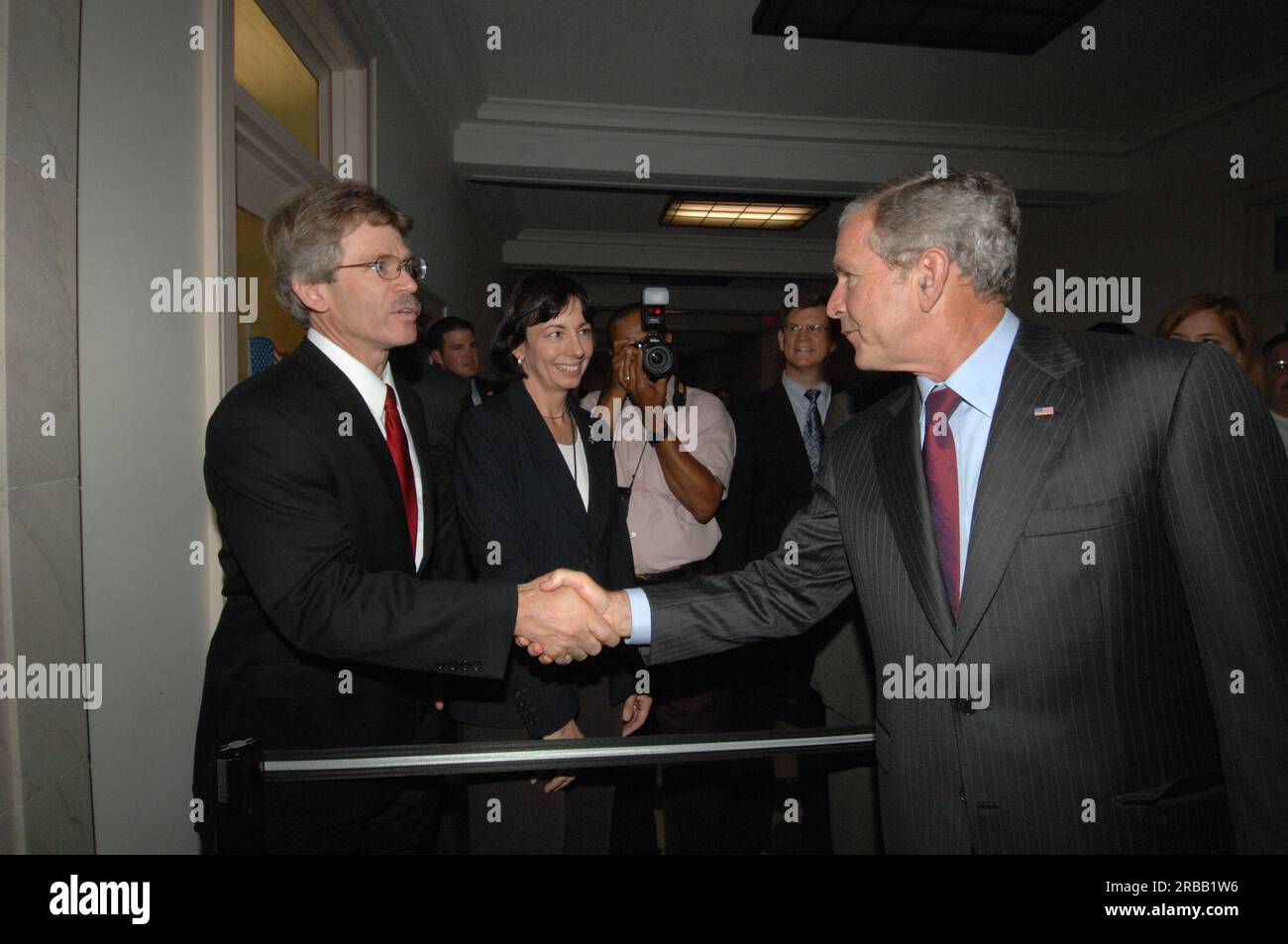 Department staff greeting President George W. Bush, from behind rope ...