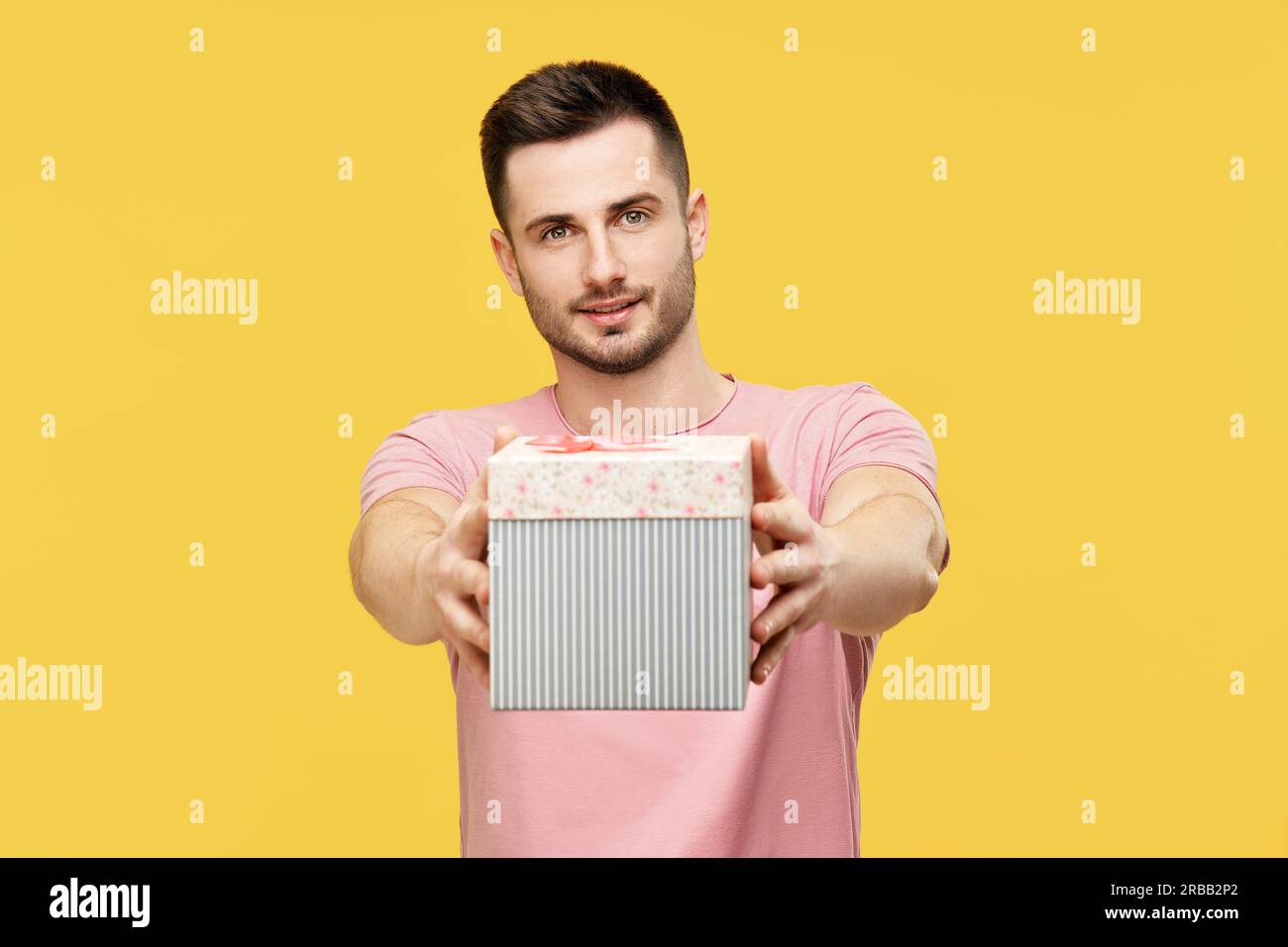 Young man giving gift box hi-res stock photography and images - Alamy