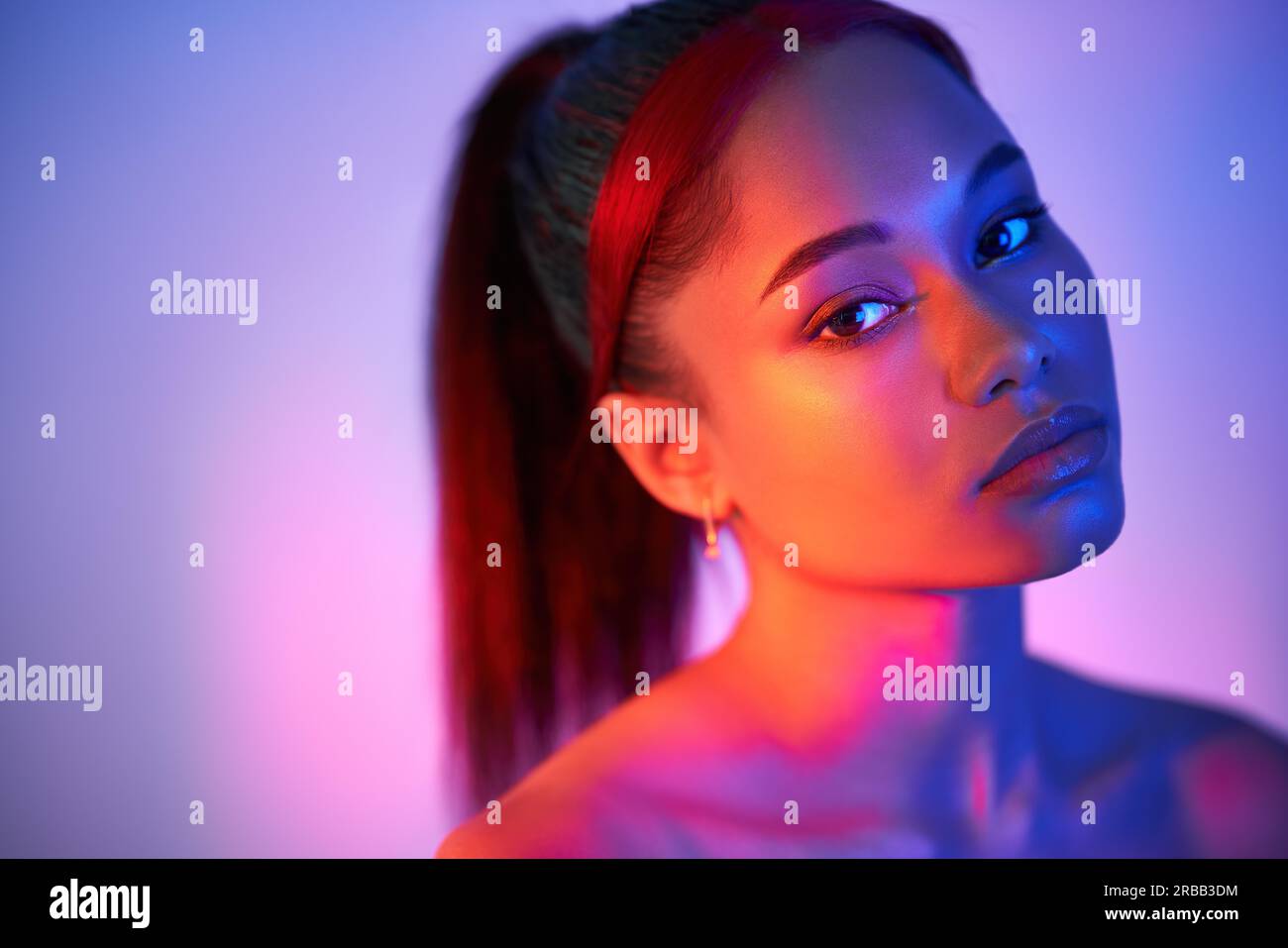 Neon light studio portrait of pretty african american woman with copy ...