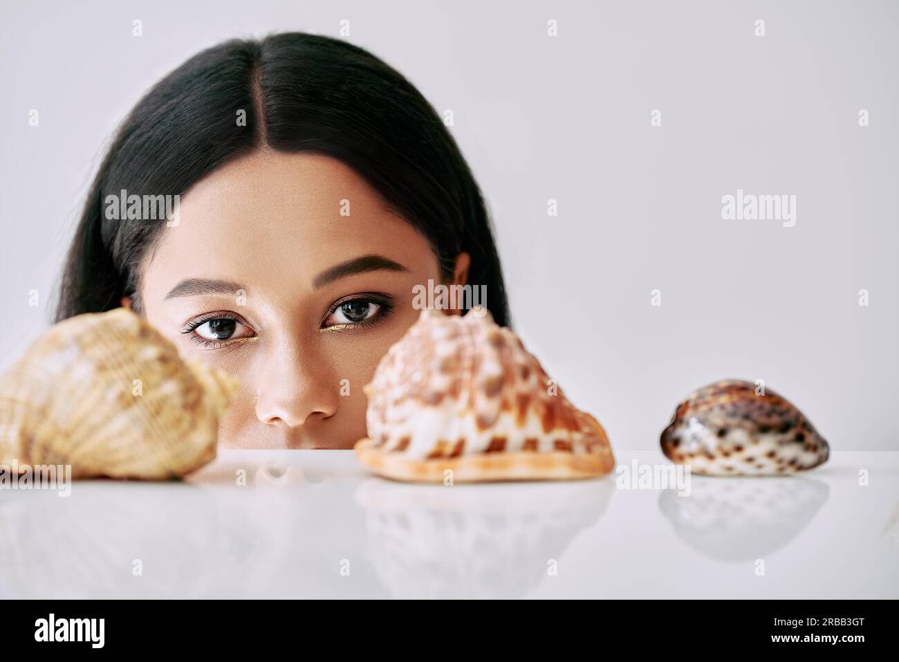 Beautiful african american woman looking on different seashells on ...